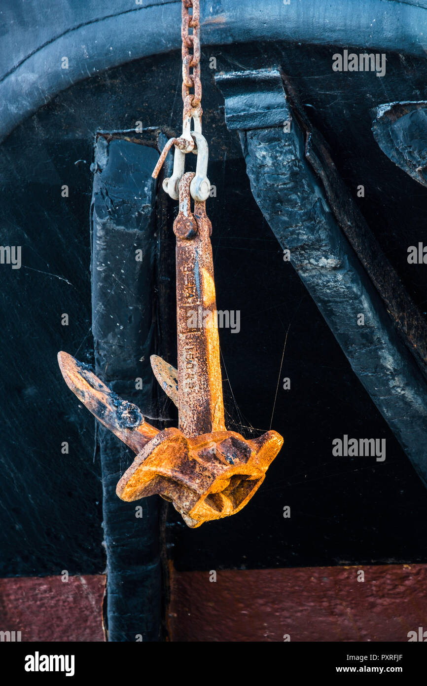 An anchor hangs from the front of a barge Stock Photo - Alamy