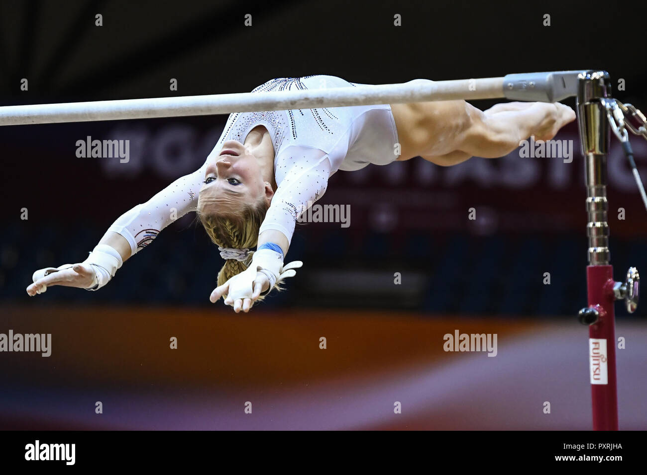 Doha, Qatar. 23rd Oct, 2018. RILEY MCCUSKER practices on the uneven ...