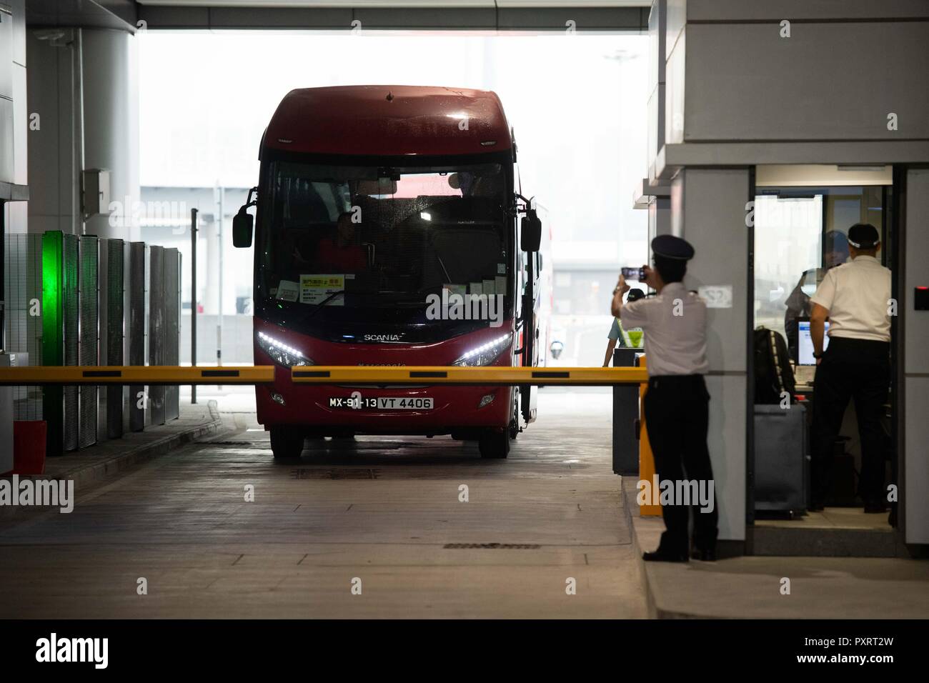 Macao, China. 24th Oct, 2018. A shuttle bus goes through the Macao port ...