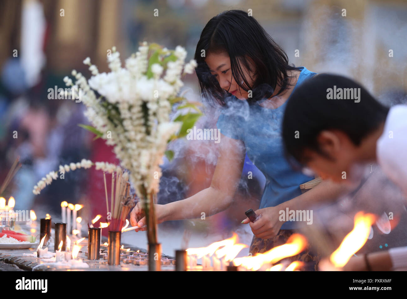 Yangon, Myanmar. 24th Oct, 2018. People light candles to pray on ...