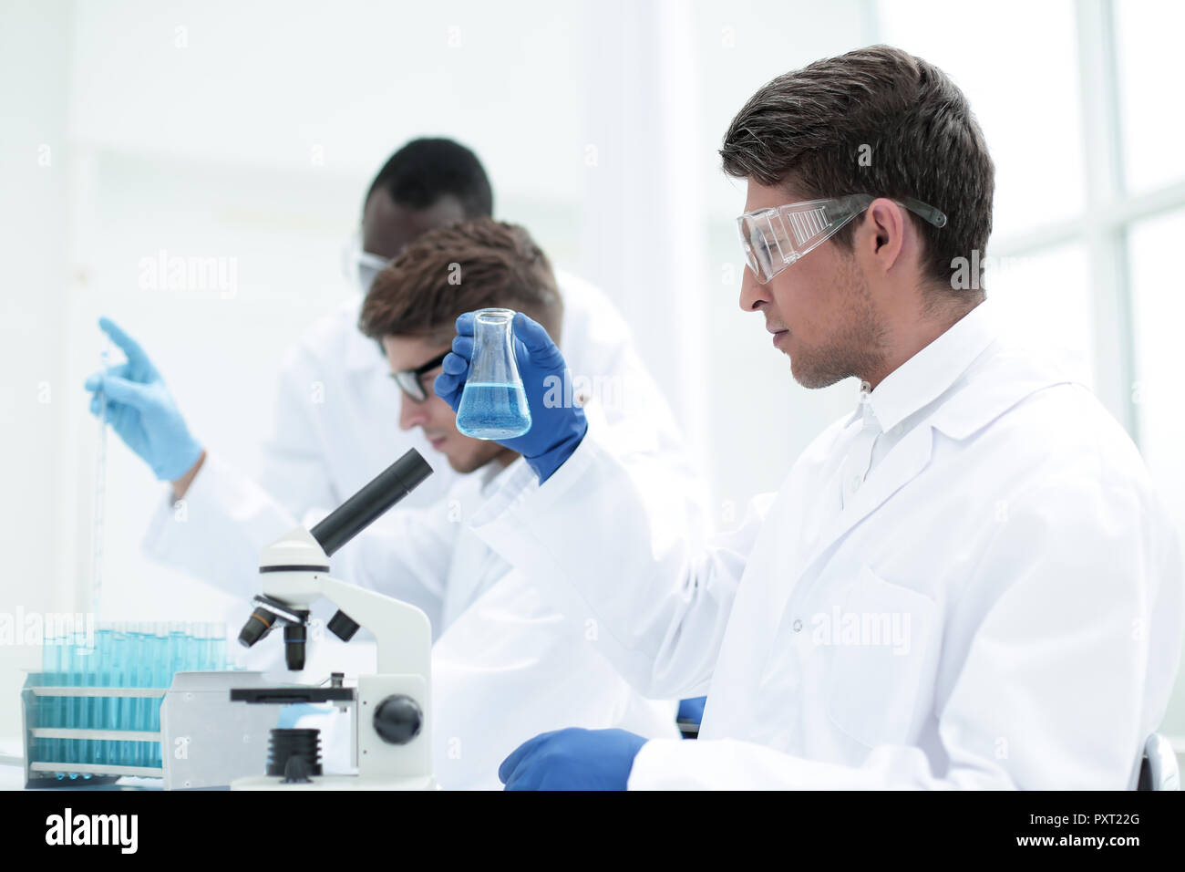 group of young scientists conduct laboratory studies Stock Photo - Alamy