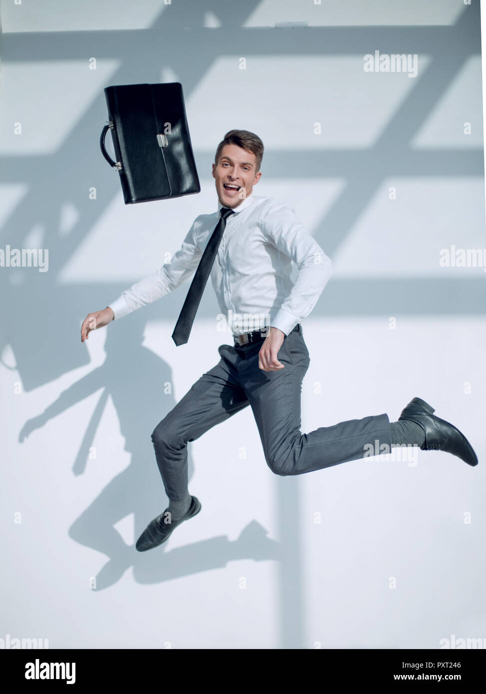 business man jumping in the air with a large smile on his face Stock ...