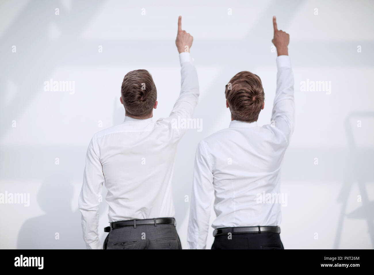 two people point a finger up Stock Photo - Alamy