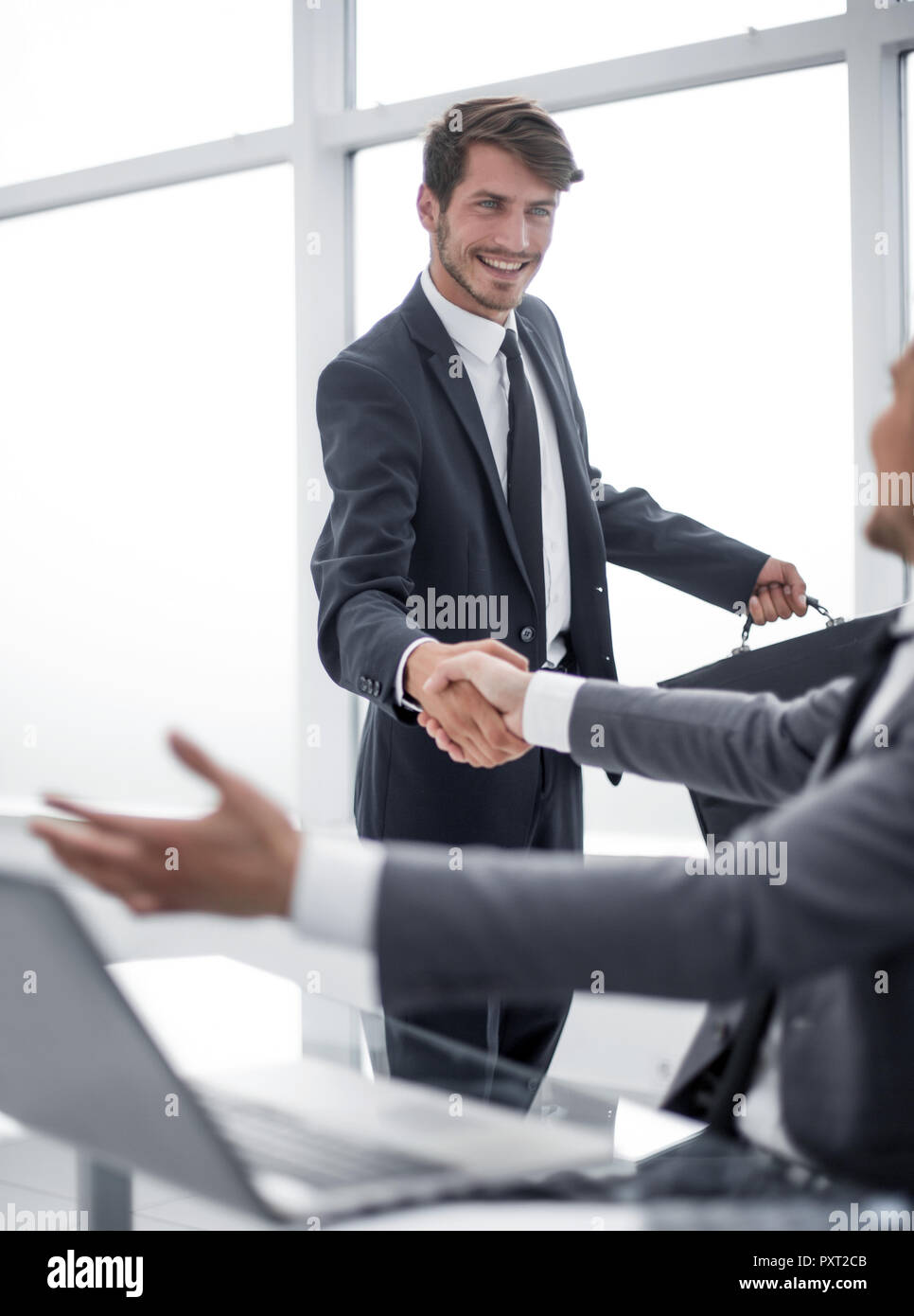 Two businessmen shake hands Stock Photo - Alamy