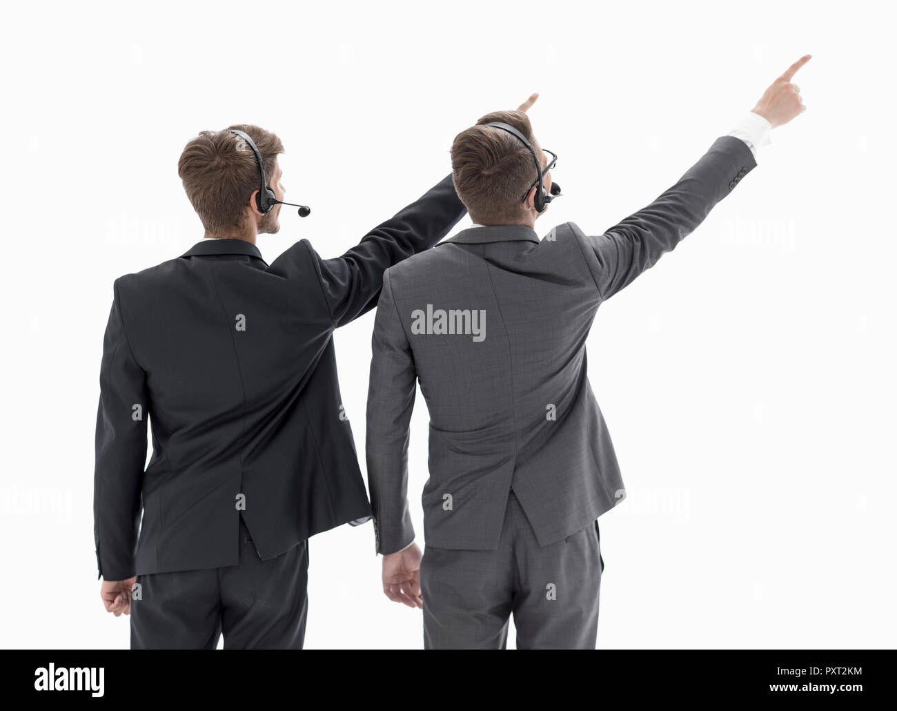 Rear view of two young business man pointing at copy space isola Stock ...