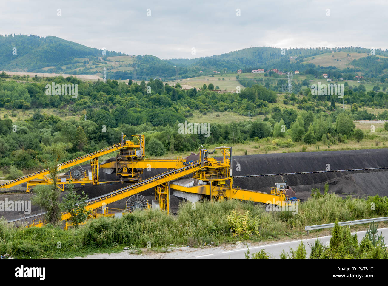 Huge industrial machine for coal mining in hilly landscape Stock Photo ...