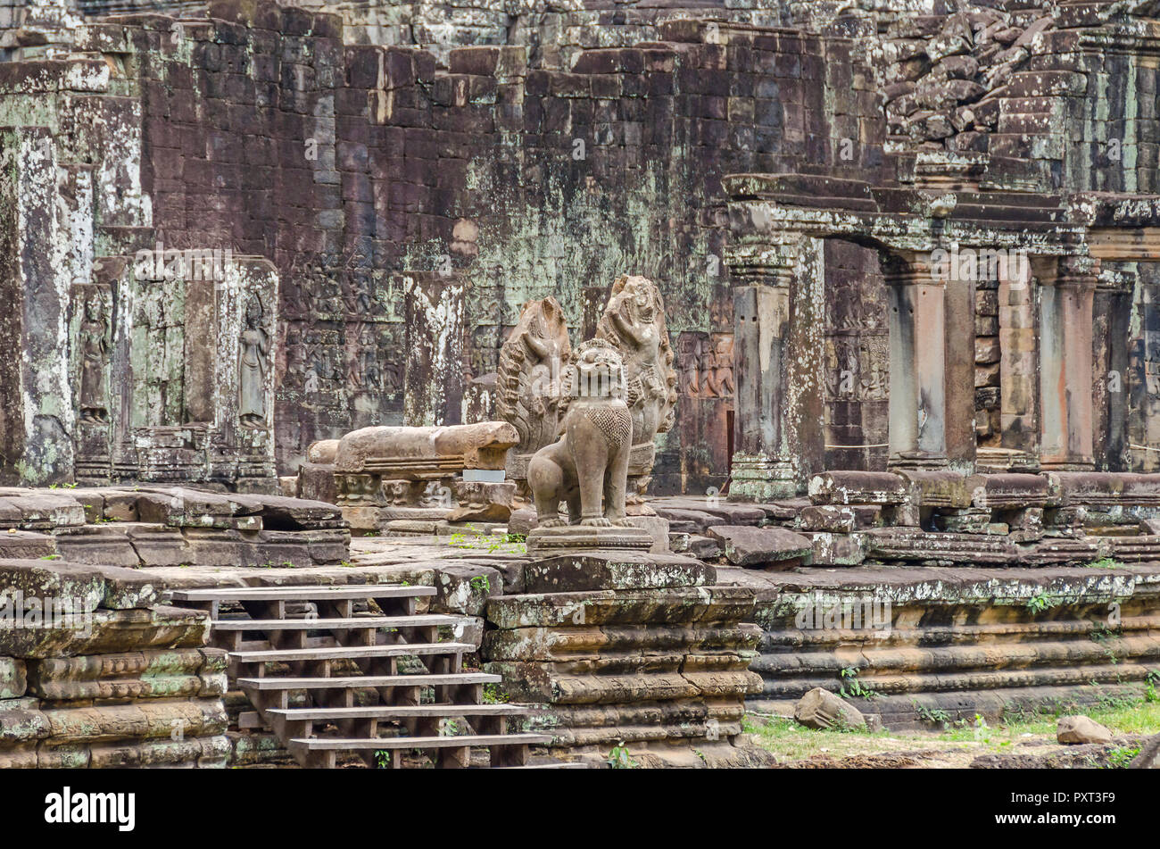 Unrestaured guardian statues of a Cambodian naga, garudas and a lion ...