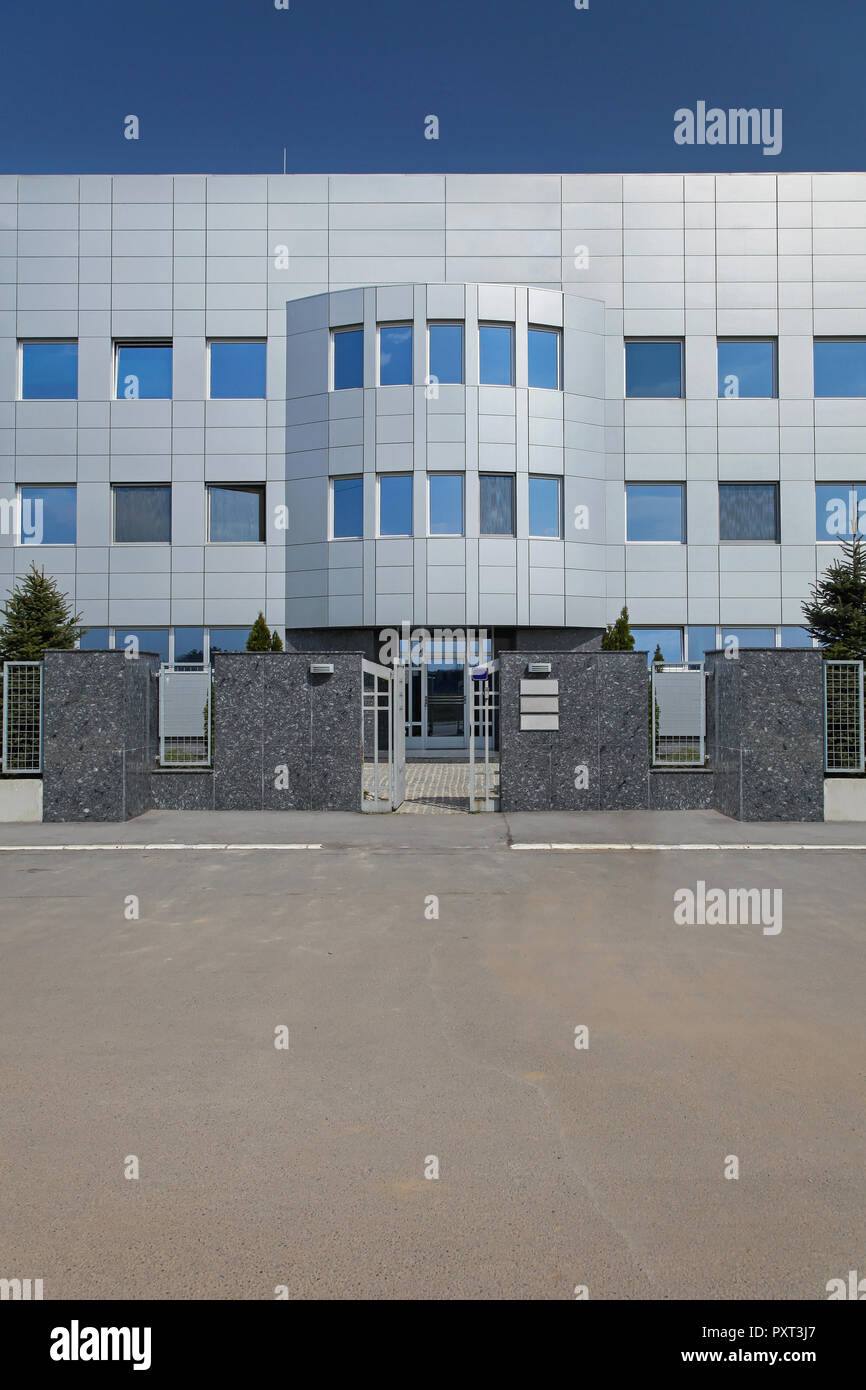 Silver metal office building with blue windows Stock Photo - Alamy