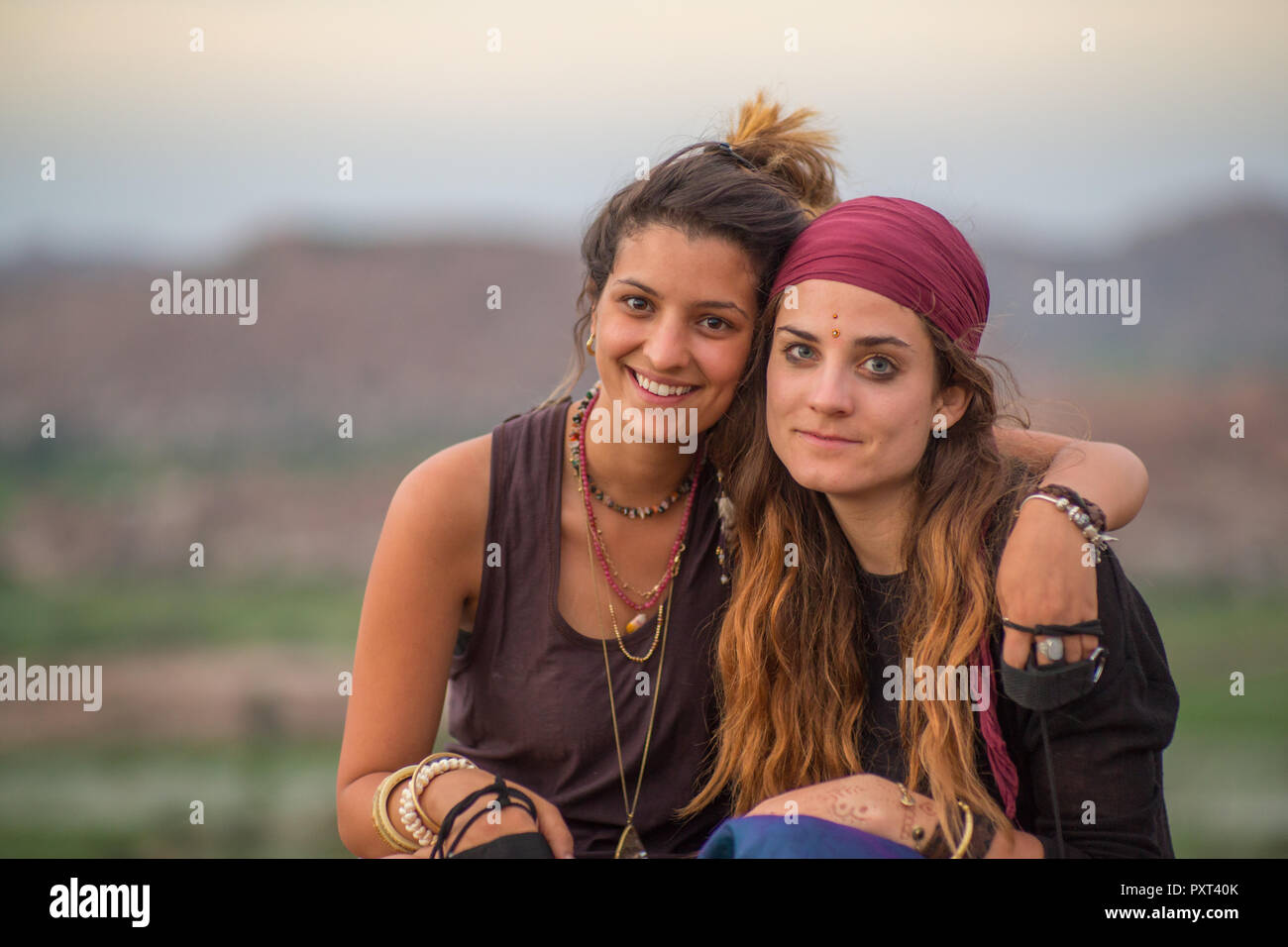 Two backpacker girls at a sunset view point in Hampi, India Stock Photo ...