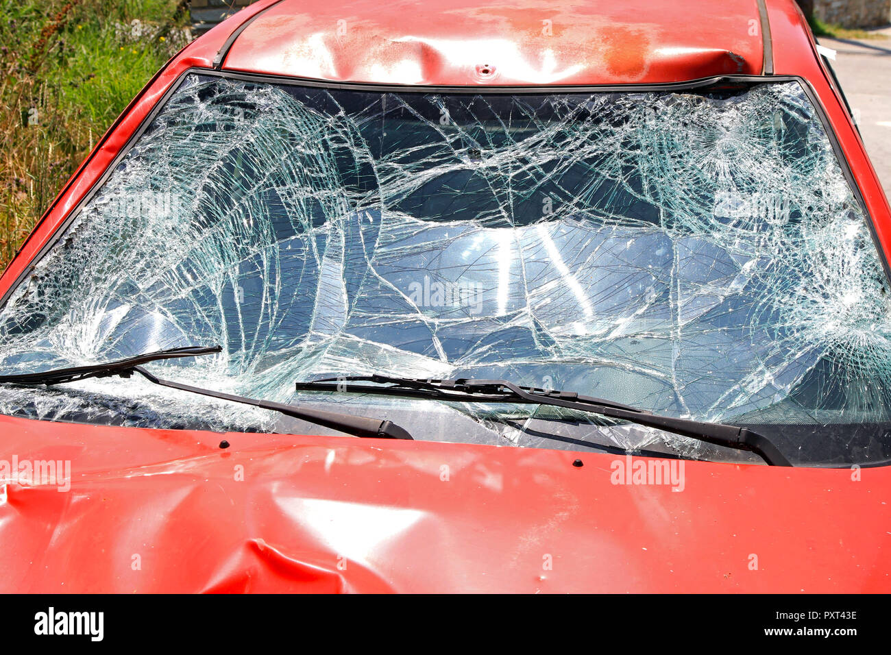 Broken windscreen at red car in traffic accident Stock Photo - Alamy