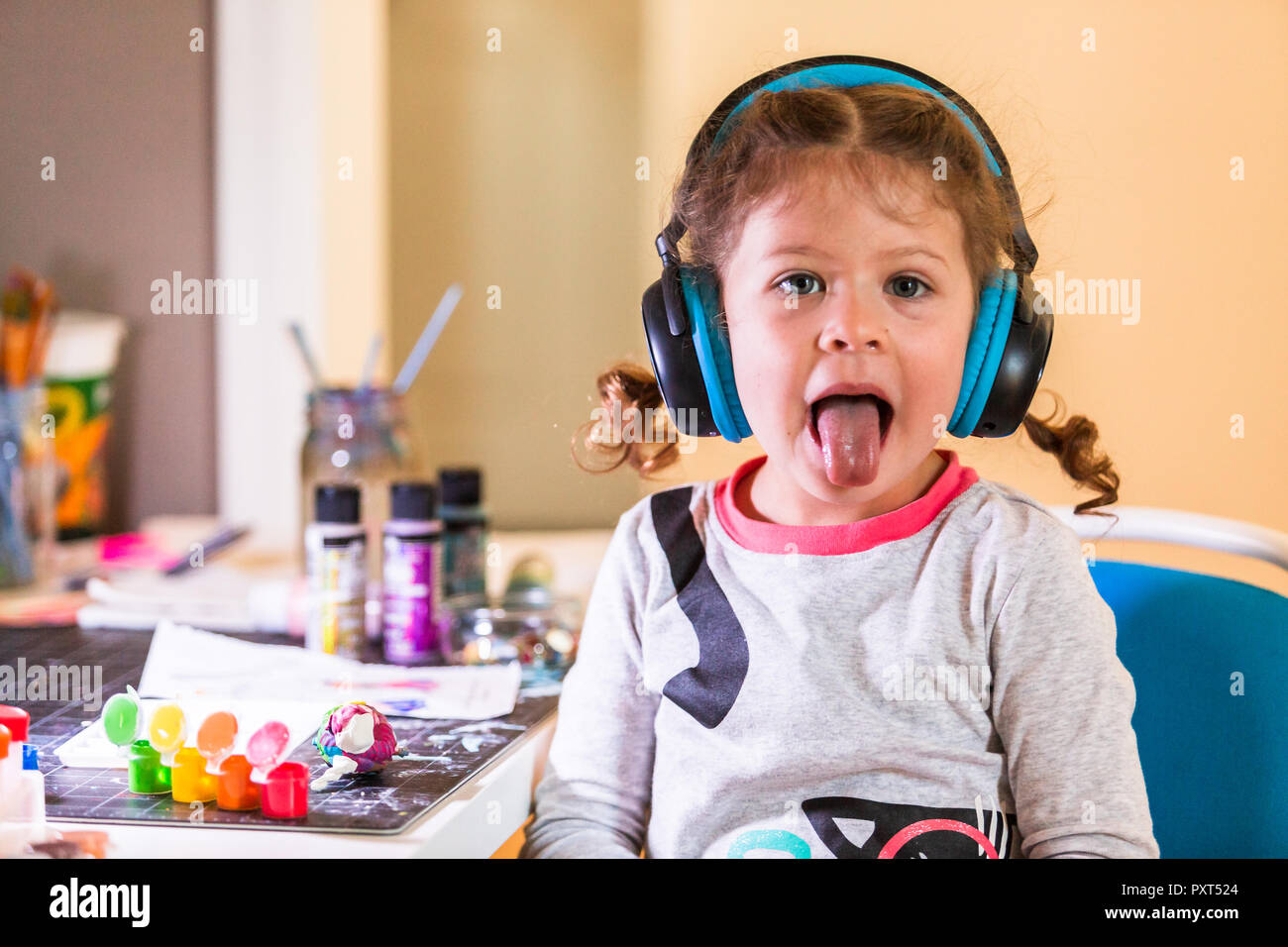 Little girl working on her art project at her desk at home Stock Photo ...