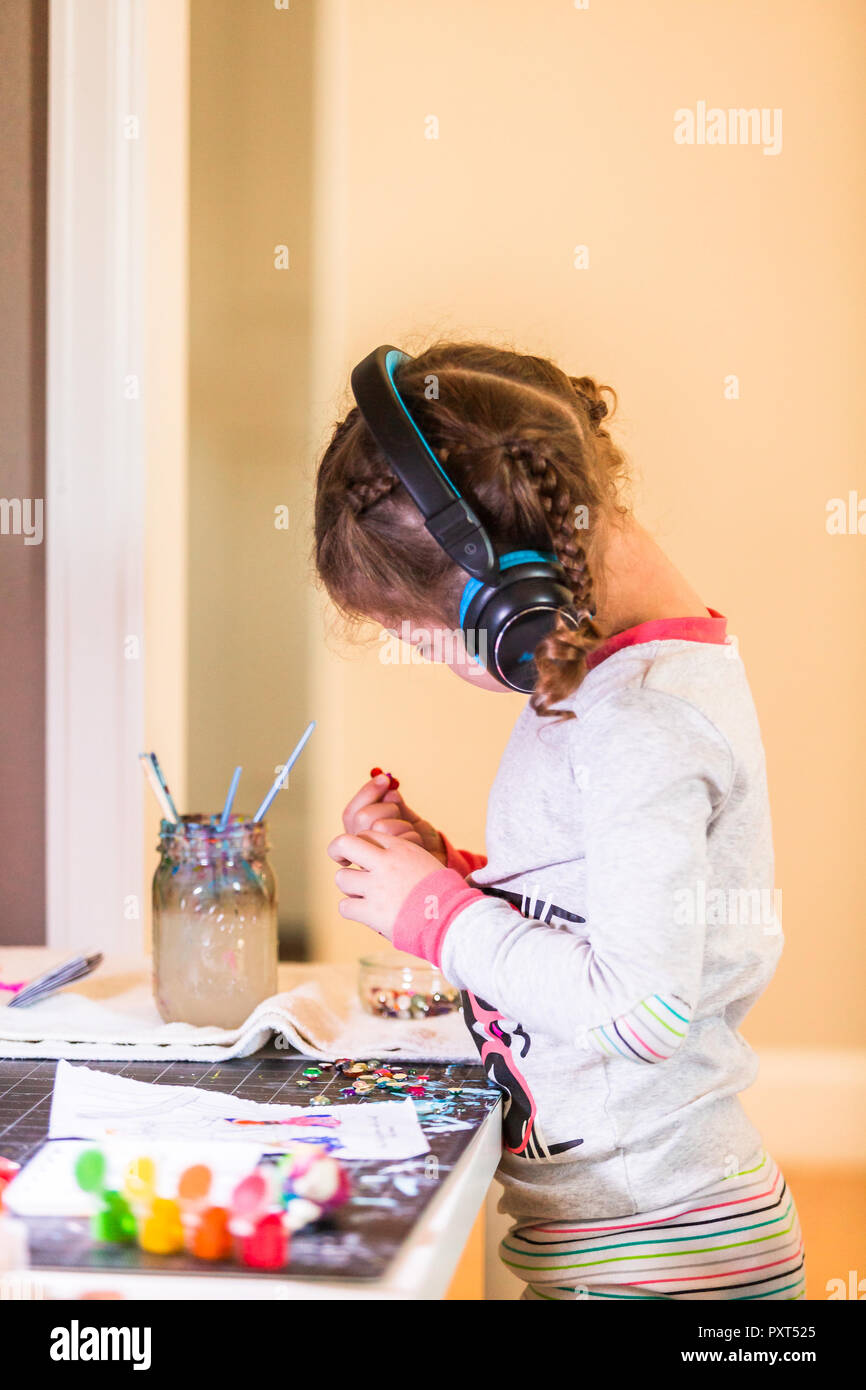 Little girl working on her art project at her desk at home Stock Photo ...