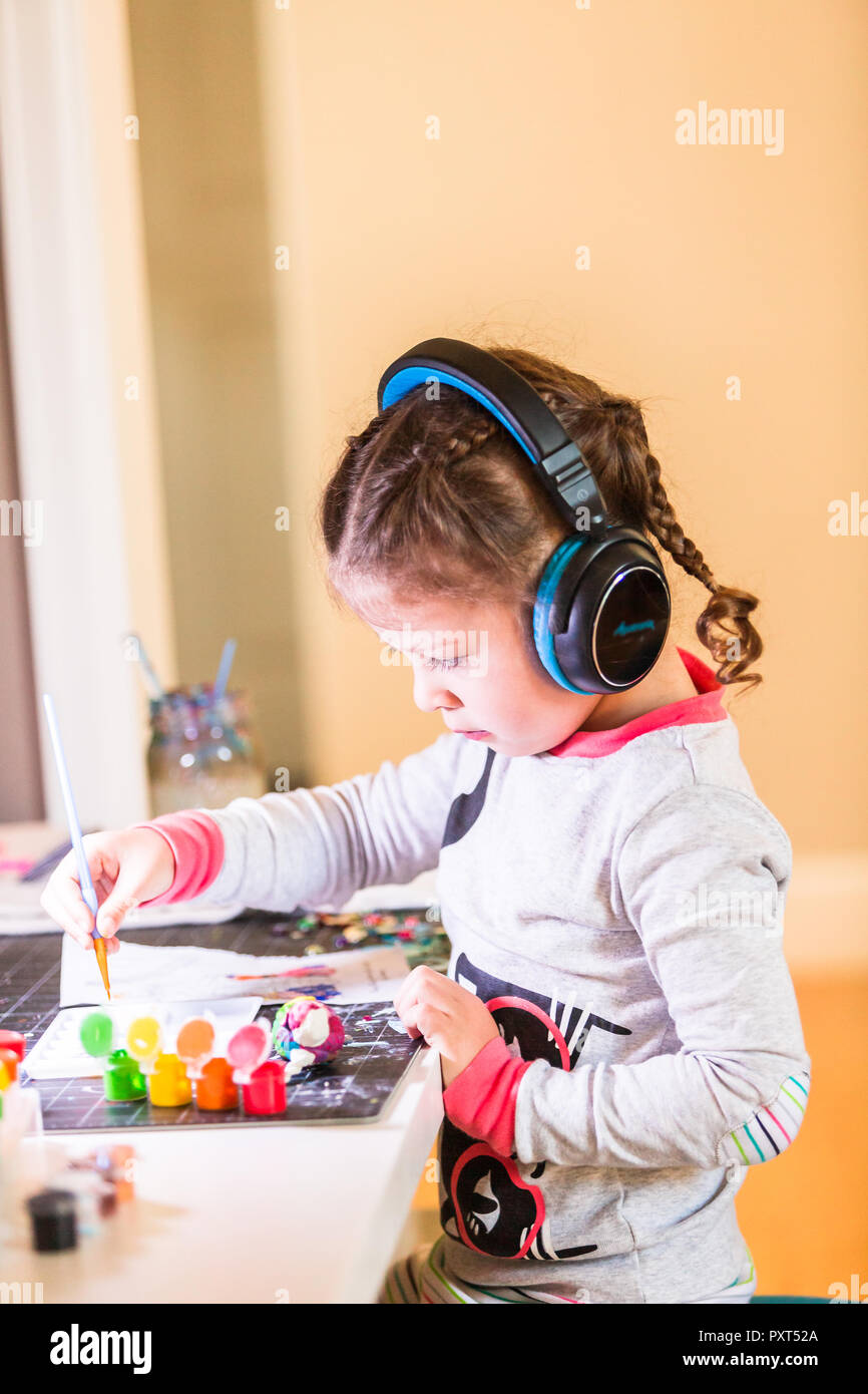 Little girl working on her art project at her desk at home Stock Photo ...