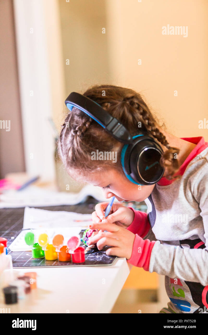 Little girl working on her art project at her desk at home Stock Photo ...