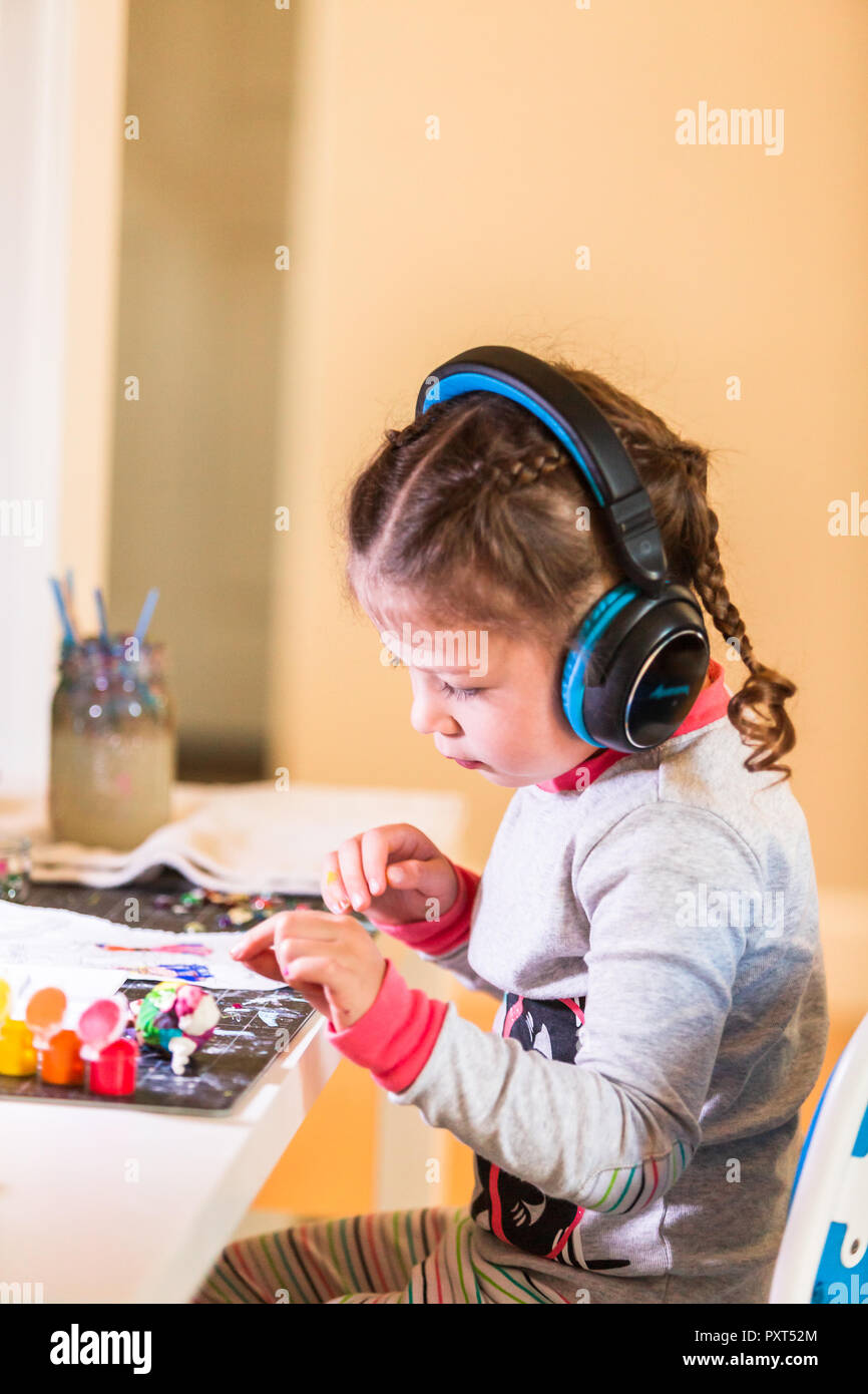 Little girl working on her art project at her desk at home Stock Photo ...