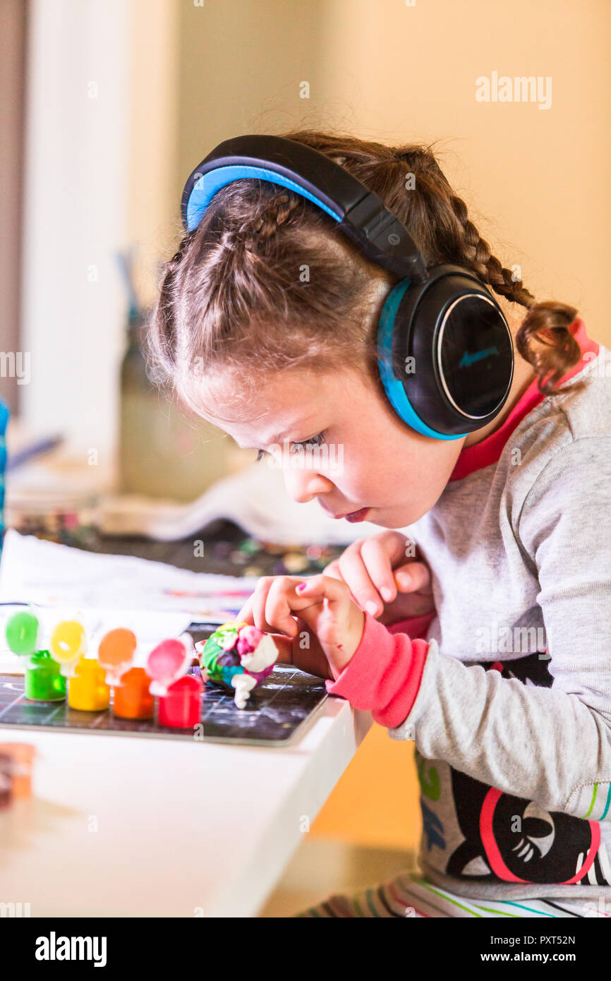 Little girl working on her art project at her desk at home Stock Photo ...