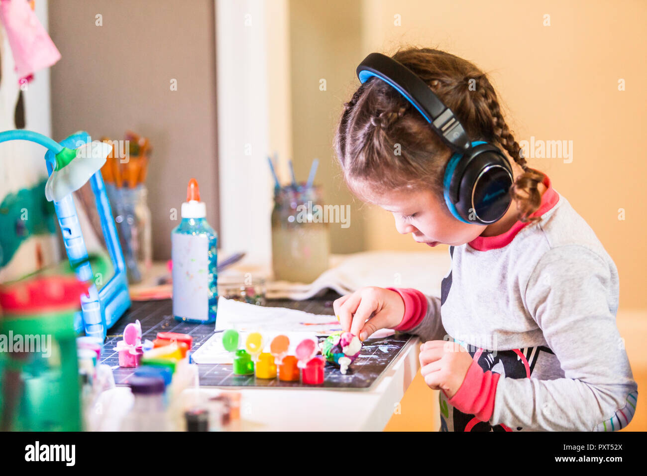Little girl working on her art project at her desk at home Stock Photo ...