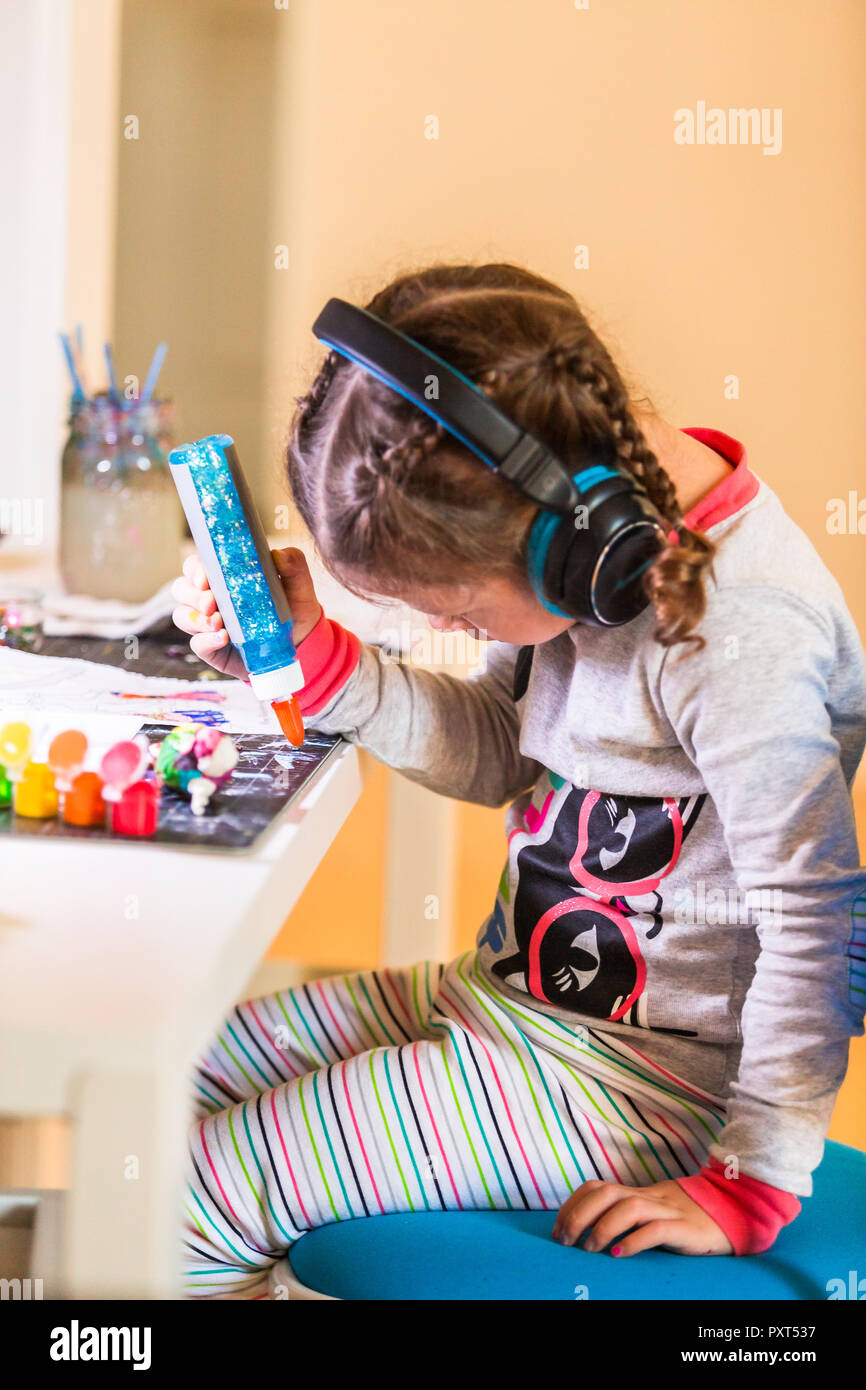 Little girl working on her art project at her desk at home Stock Photo ...