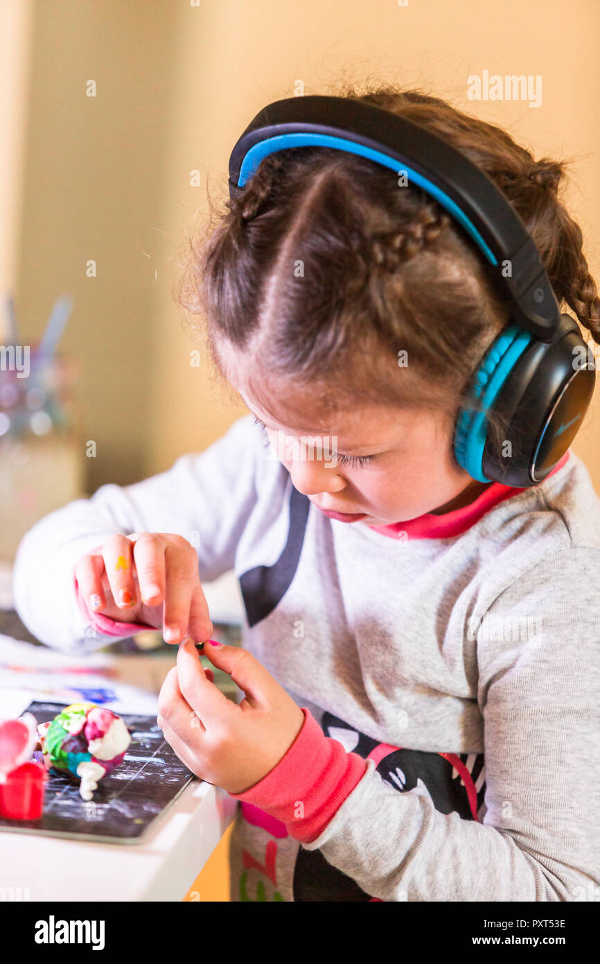 Little girl working on her art project at her desk at home Stock Photo ...