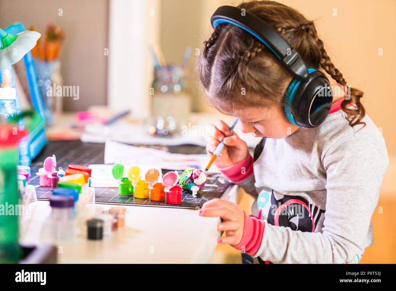 Little girl working on her art project at her desk at home Stock Photo ...