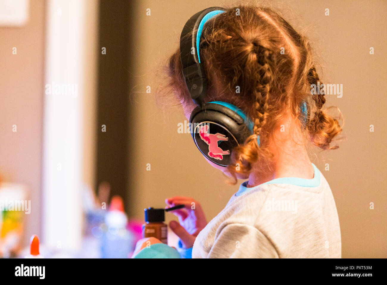 Little girl working on her art project at her desk at home Stock Photo ...