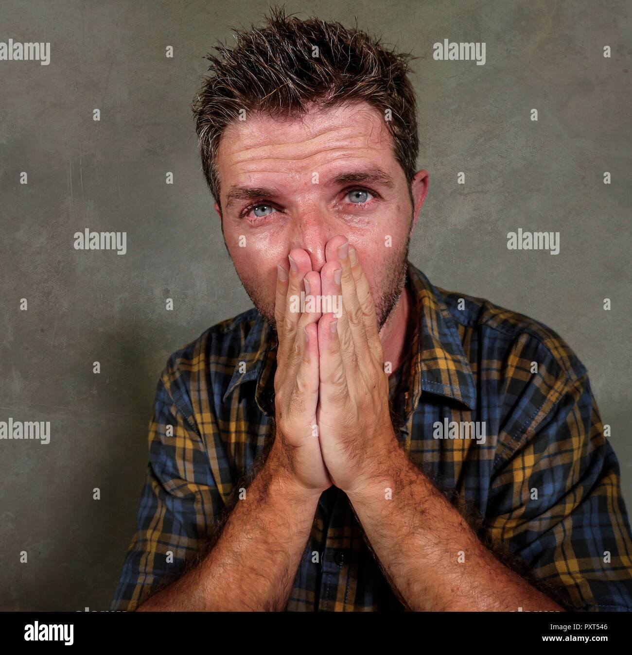dramatic portrait of young sad and depressed man feeling anxious and ...