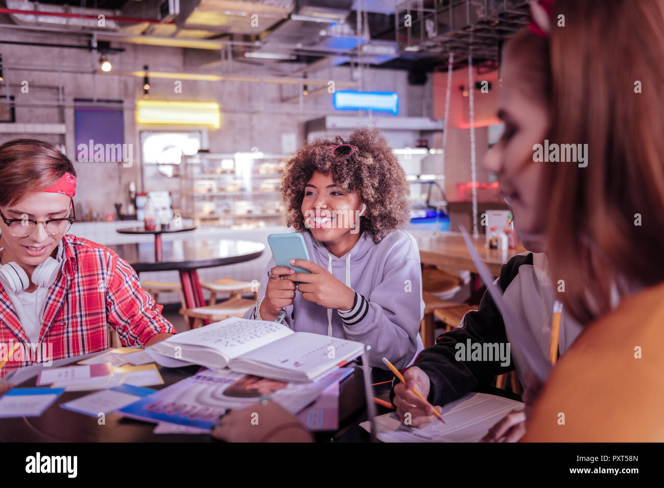 Positive delighted students completing their home tasks Stock Photo - Alamy