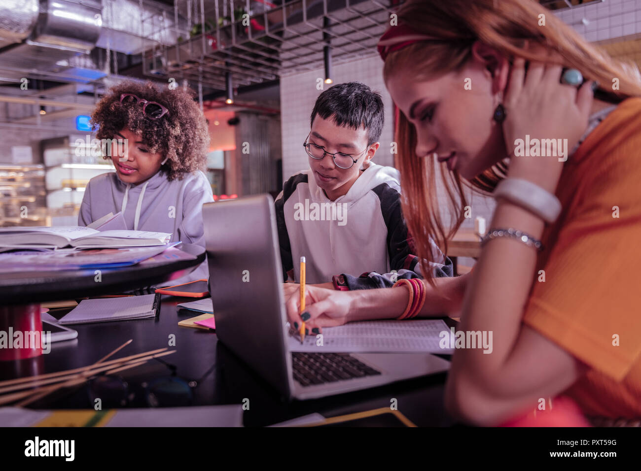 Concentrated red haired girl staring at her notes Stock Photo - Alamy
