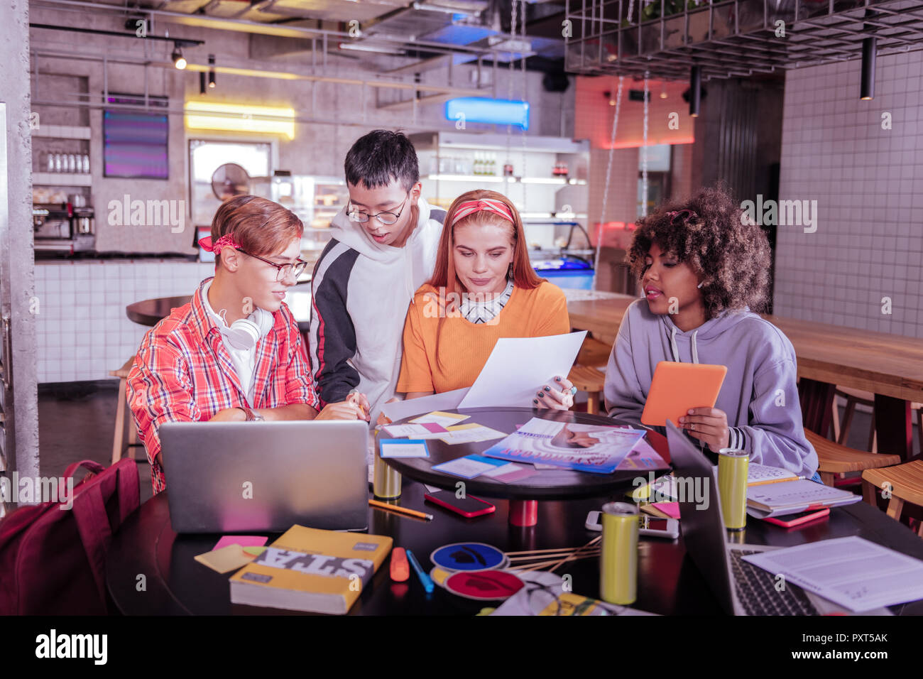 Joyful students completing tasks for project together Stock Photo - Alamy