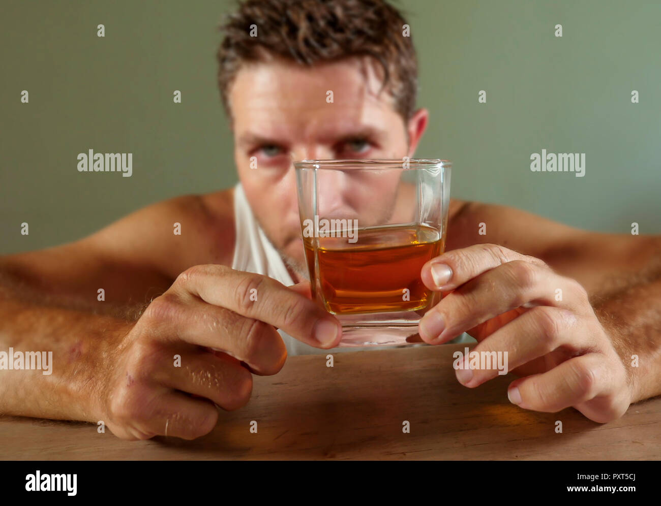 isolated portrait of young messy depressed alcoholic man having a drink ...