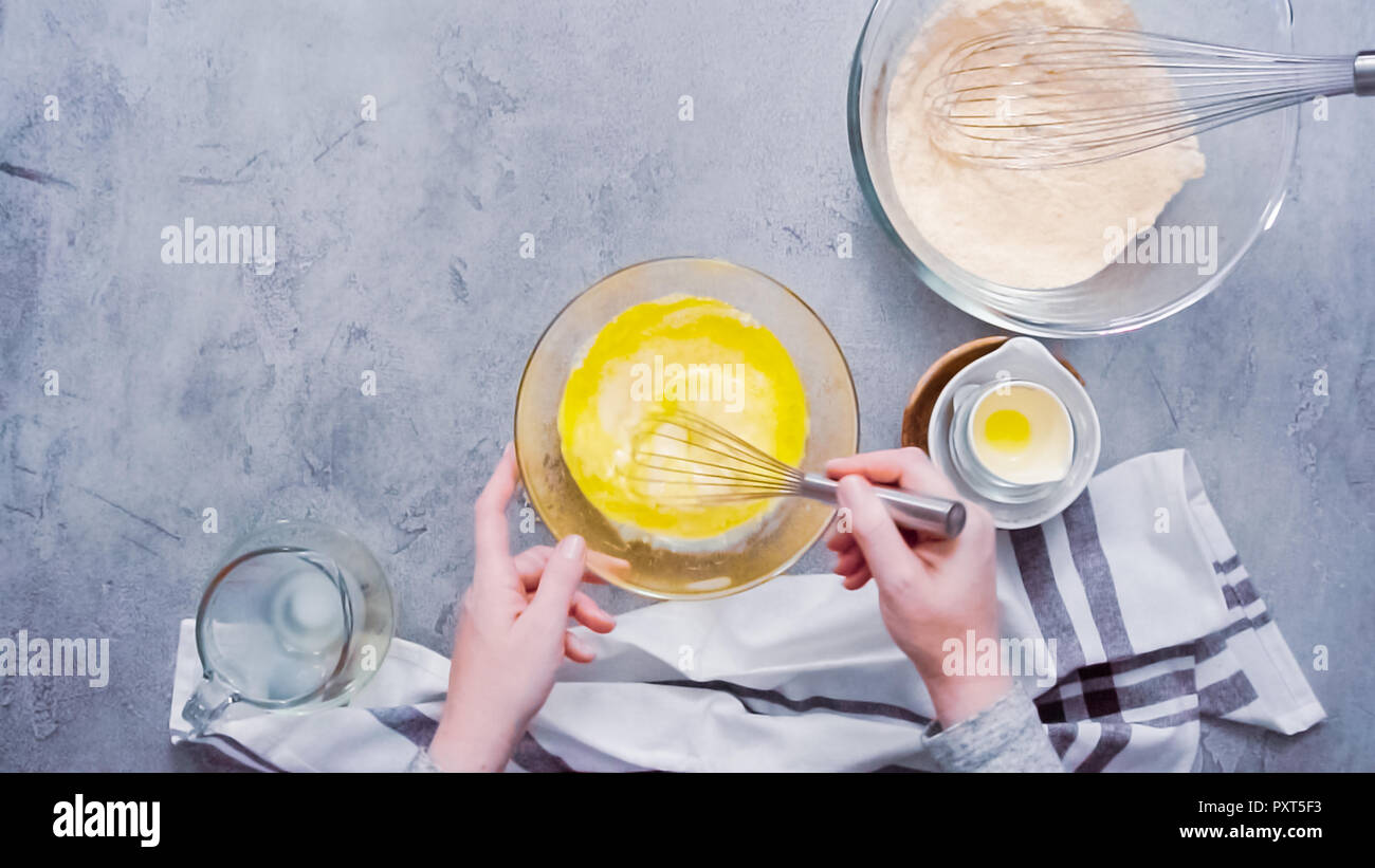 Step by step. Flat lay. Mixing ingredients together in glass mixing ...