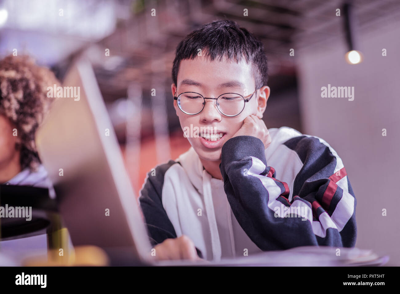 Busy international male person completing task alone Stock Photo - Alamy