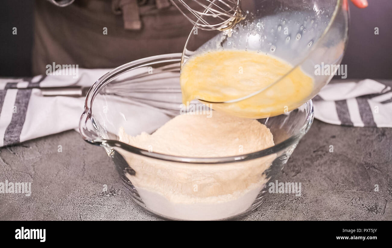 Step by step. Mixing ingredients together in glass mixing bowl for ...