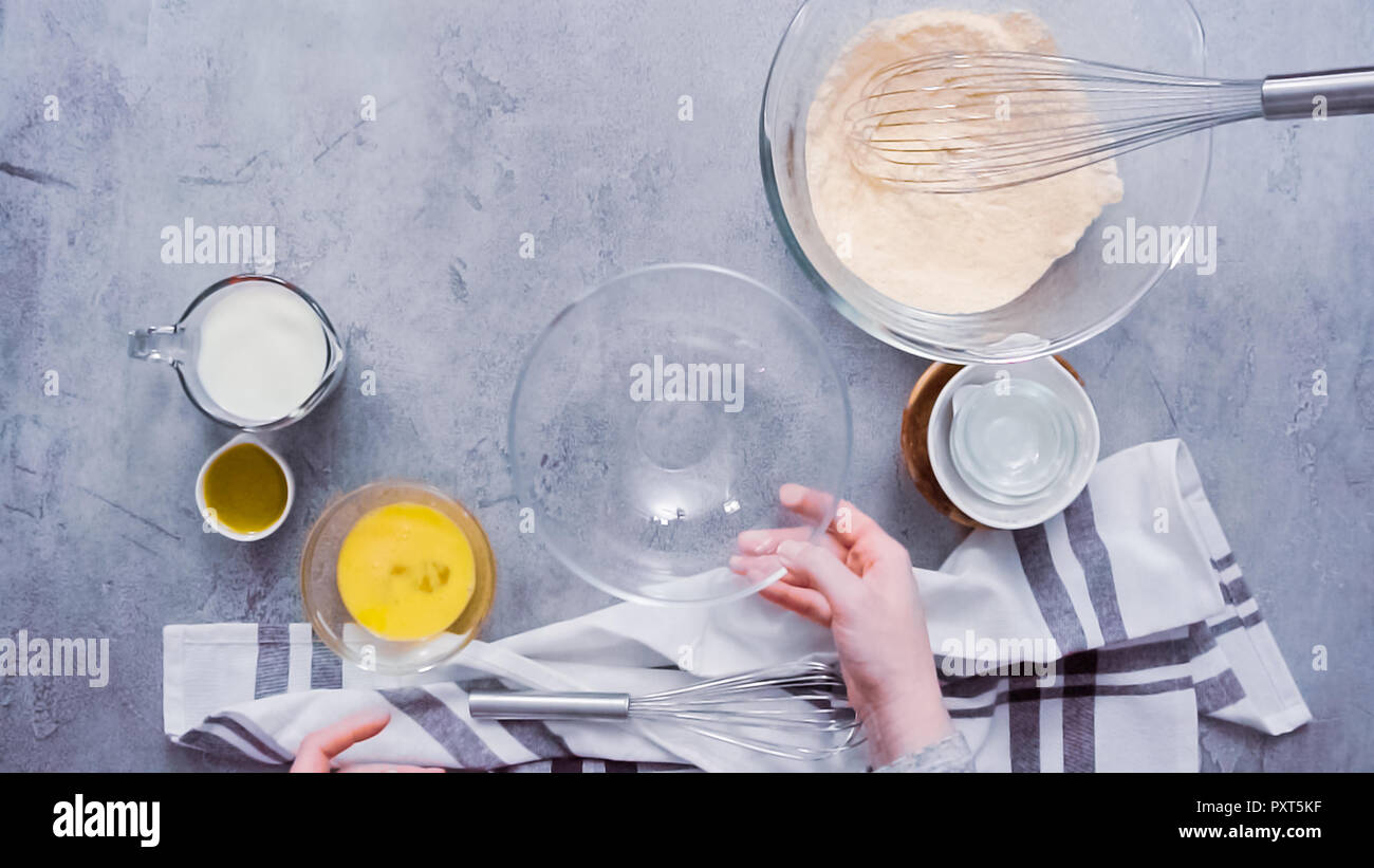 Step by step. Flat lay. Mixing ingredients together in glass mixing ...