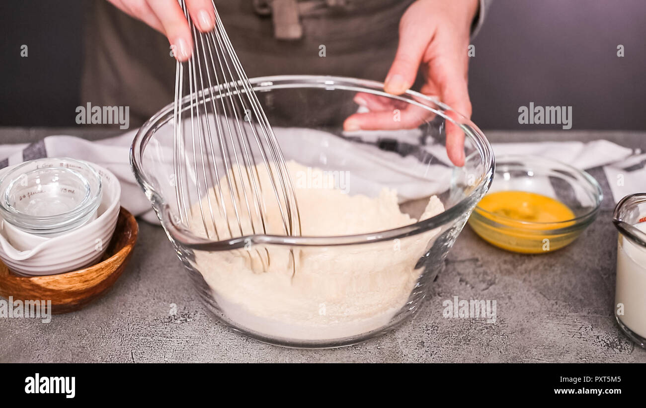 Step by step. Mixing ingredients together in glass mixing bowl for ...