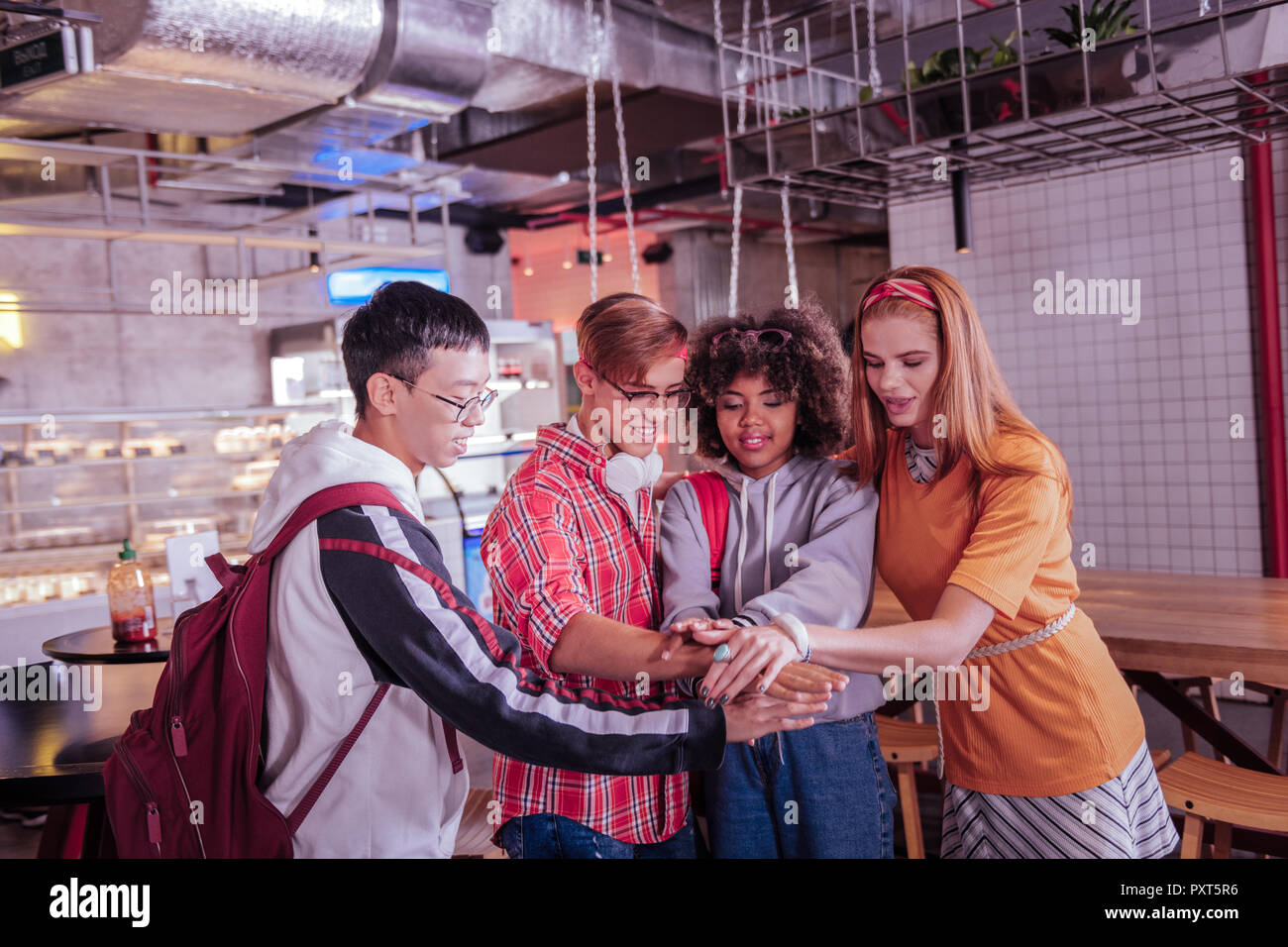 Joyful classmates celebrating their successful project work Stock Photo ...