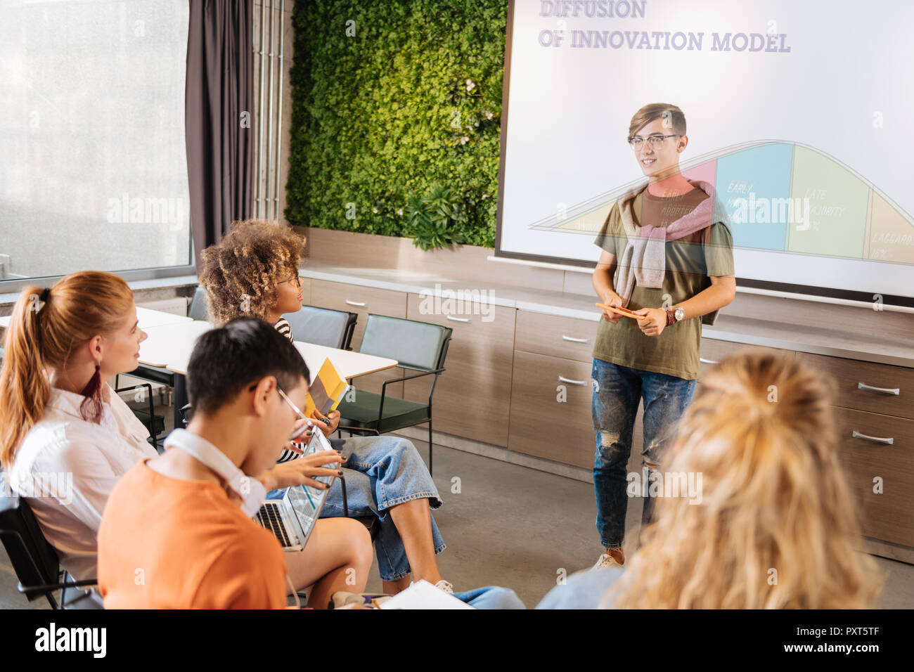 Pleased male person presenting his innovation model Stock Photo - Alamy