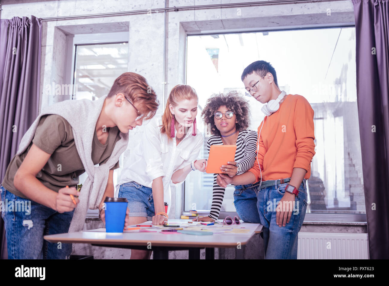 Cheerful kids staring at screen of their tablet Stock Photo - Alamy