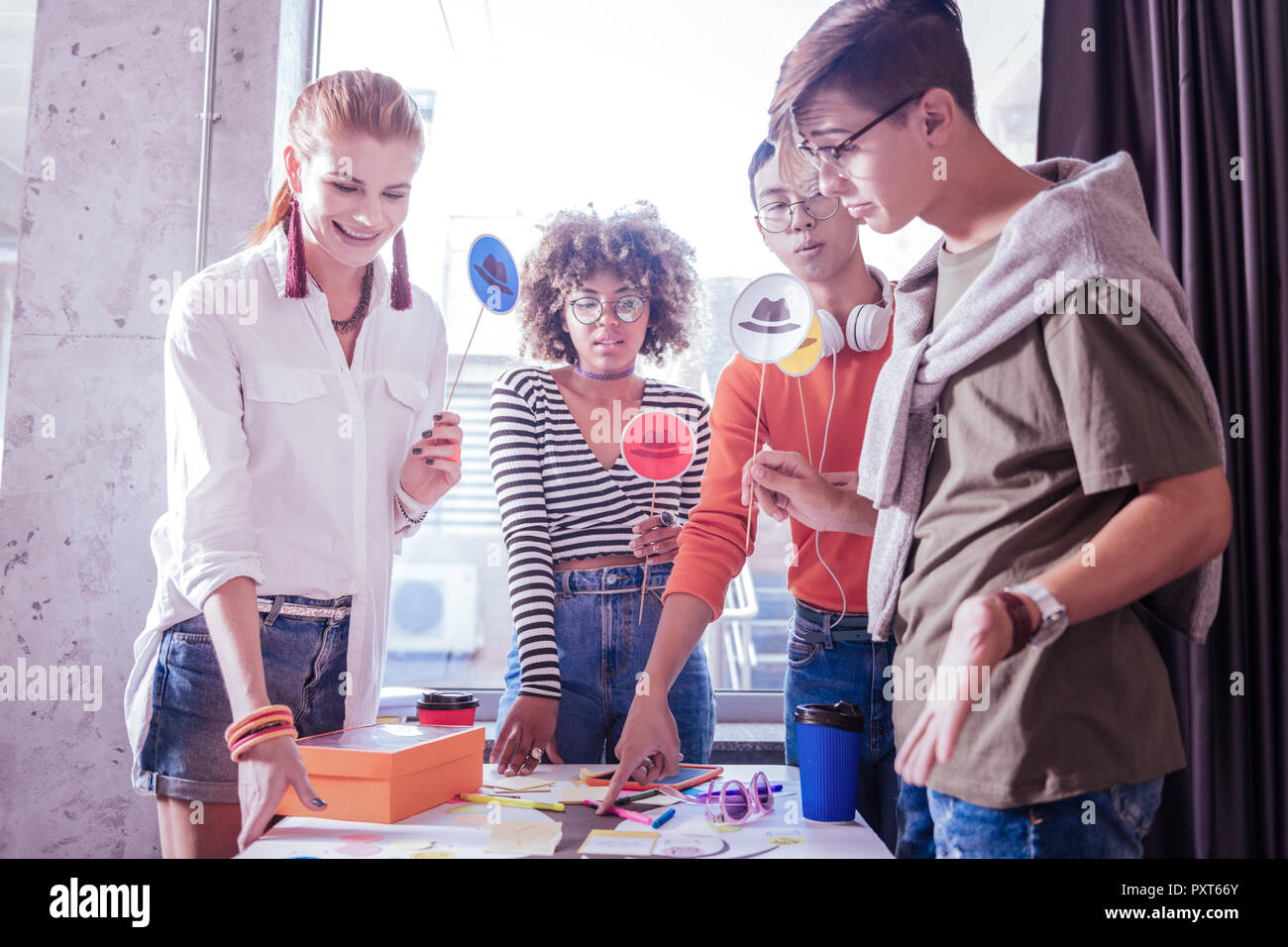 Positive delighted group mates preparing project work Stock Photo - Alamy