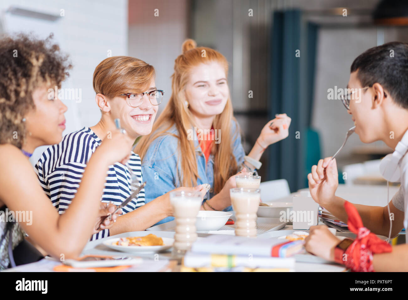 Happy classmates talking while having theirs dinner Stock Photo - Alamy