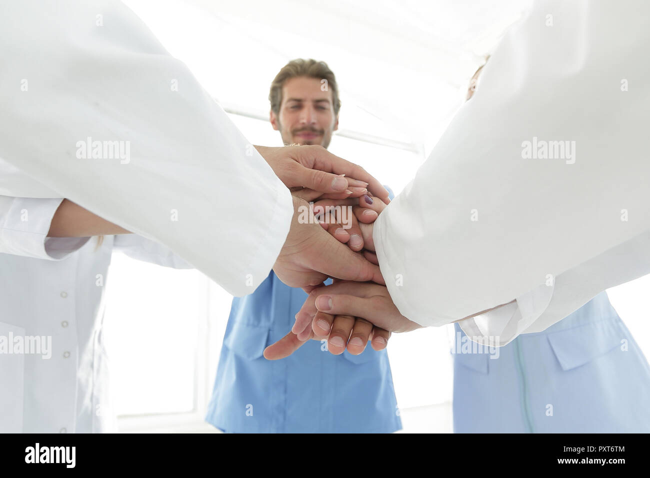 Doctors and nurses in a medical team stacking hands Stock Photo - Alamy