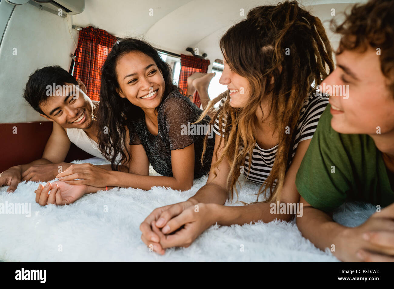 young people enjoy holiday lay down relax inside vintage van Stock ...