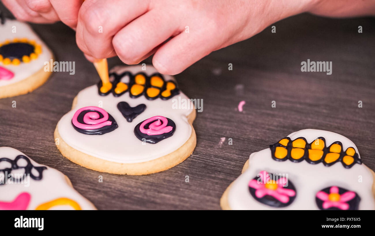 Step by step. Decorating sugar skull cookies with different color royal ...