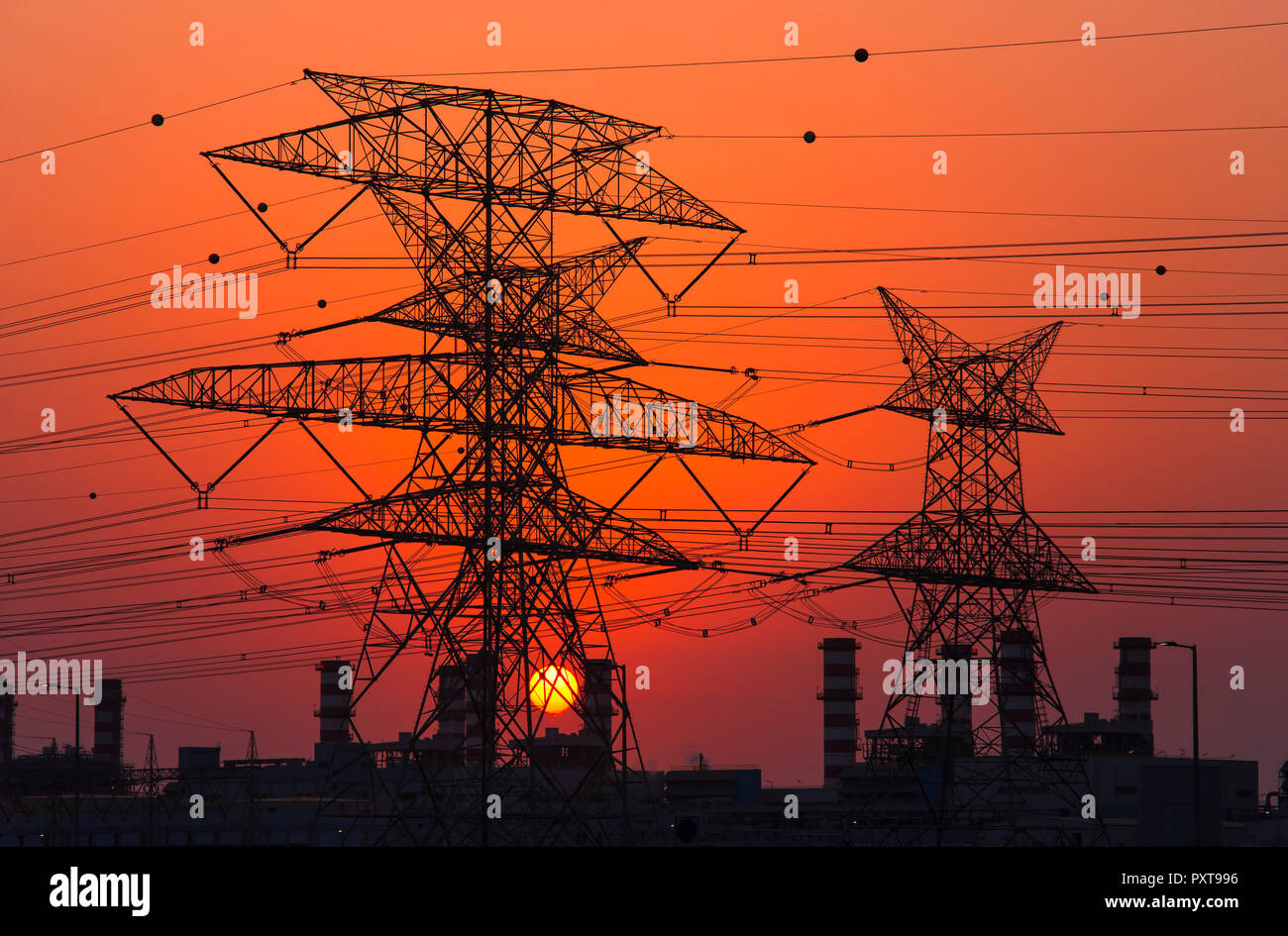 high voltage electricity pole at sunset. energy concept, industrial ...