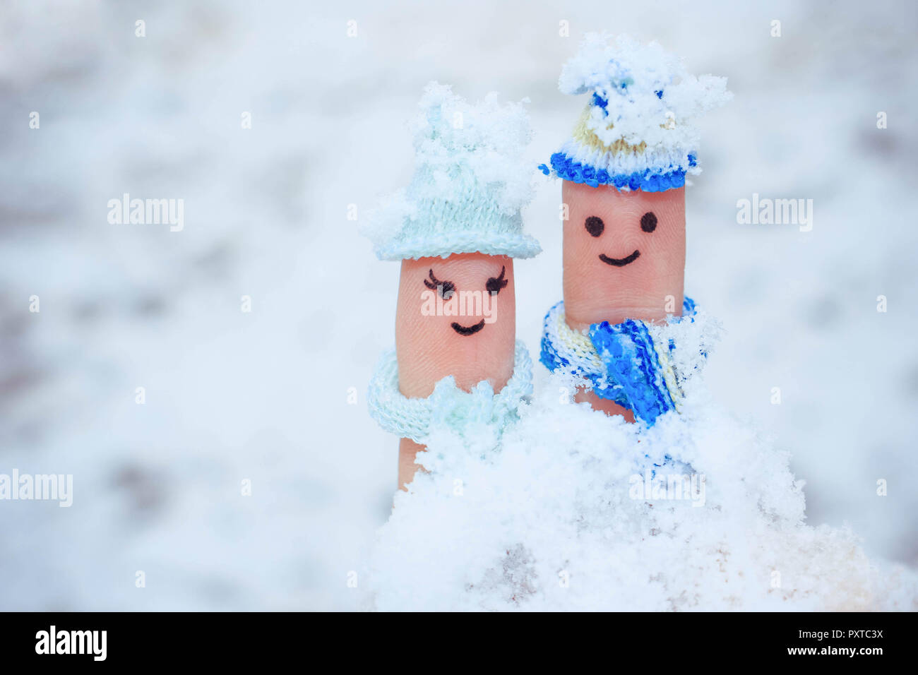 Finger art of a Happy couple on the background of snow. A man and a ...