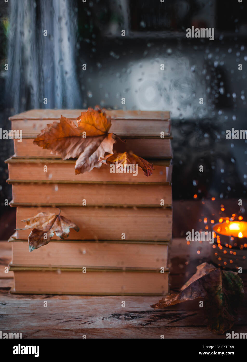 Stacked books through rainy window Stock Photo - Alamy