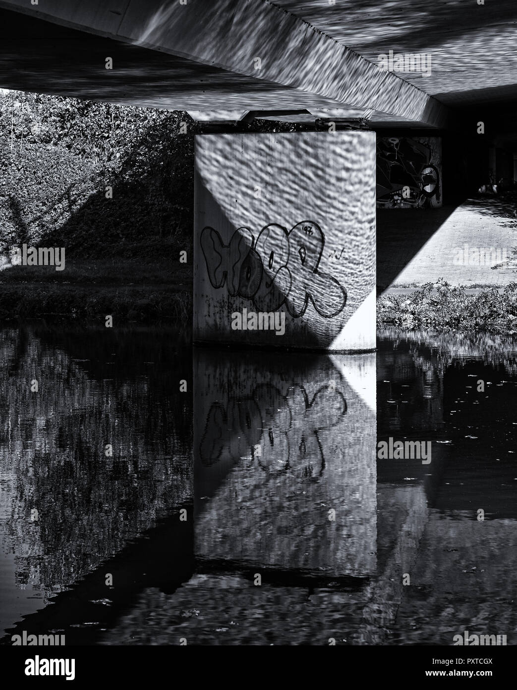 Shadows and reflections underneath a bridge intersecting in the shape ...