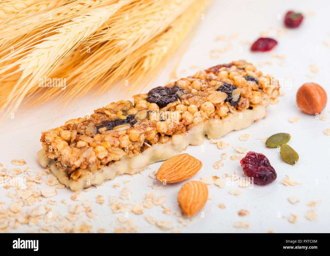 Homemade organic granola cereal bar with nuts and dried fruit on white ...