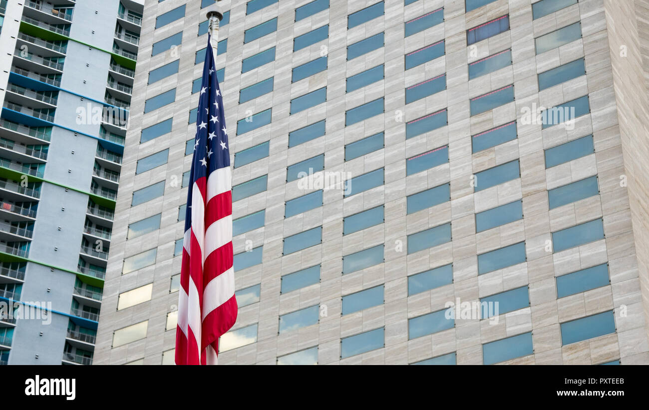 American flag resting in front of modern corporate building Stock Photo ...