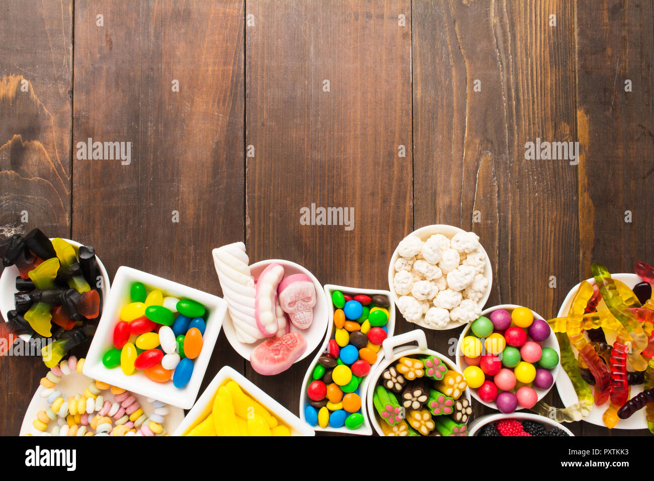 Sweet candies food like unhealthy concept over brown wooden table with ...